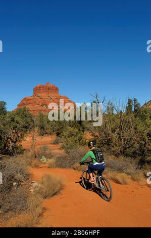 A mountain biker with Bell Rock Butte in Sedona, Arizona, USA Stock ...