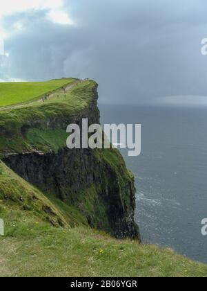 colorful ocean views, green grassy rocks, rocks and blue water. The ...