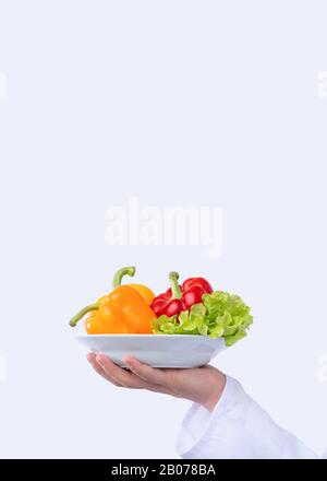 Waiter with fresh salad on white background Stock Photo - Alamy