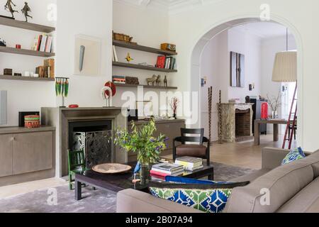 Interior of light living room with soft couch, armchair and coffee ...