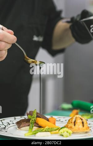 Chef is making final touch to the plate Stock Photo - Alamy