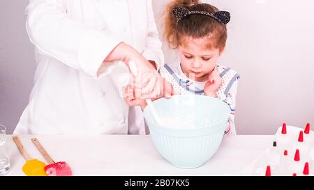 Step by step. Mixing royal icing to decorate sugar cookies Stock Photo ...