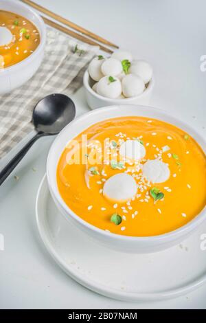 Hobak juk, korean traditional pumpkin porridge soup, with rice balls ...
