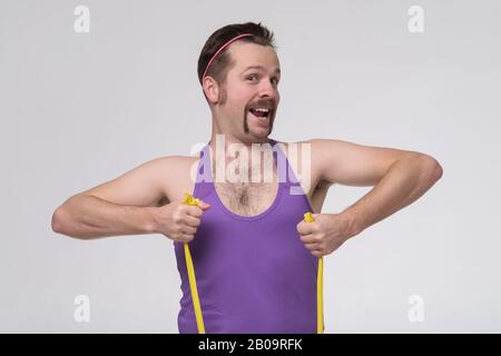 sportsman with resistance expander isolated on grey background ...
