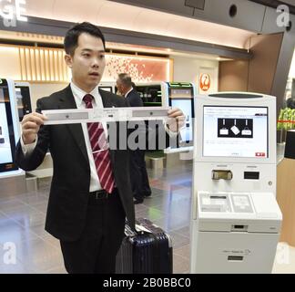 Japan Airlines check-in baggage machine display showing the two steps ...