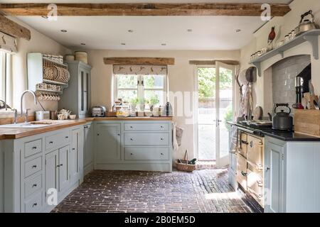 Light blue fitted kitchen with cobblestone flooring Rayburn in kitchen ...