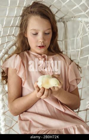 Adorable little girl playing with rabbits at farm. Child familiarizing ...