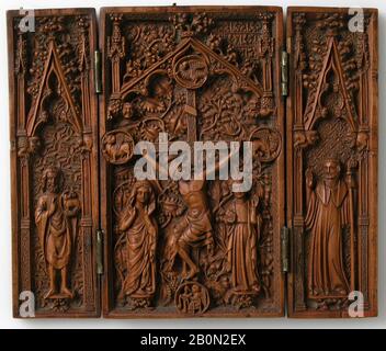 A 15th-century German crucifixion triptych made of pearwood, depicting ...