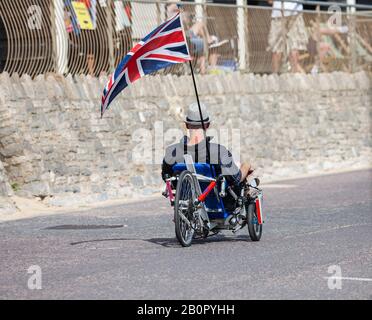 A man riding a recumbent trike bicycle rides along the Virginia Creeper ...