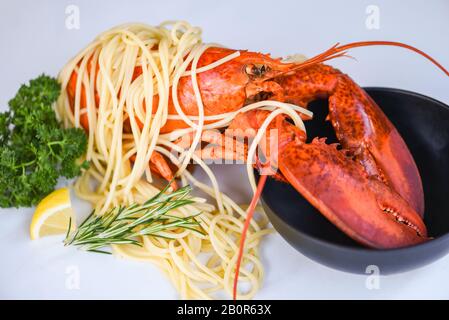 Luxury food recipe: spaghetti and boiled lobster, tomatoes, lemon and ...