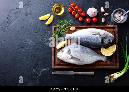Raw fishes and vegetables on stone background, healthy food Stock Photo ...