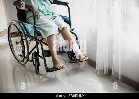 Close up of patient's leg is splinted sitting a wheelchair in the ...