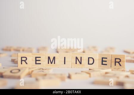 REMINDER wooden tile font concept Stock Photo - Alamy