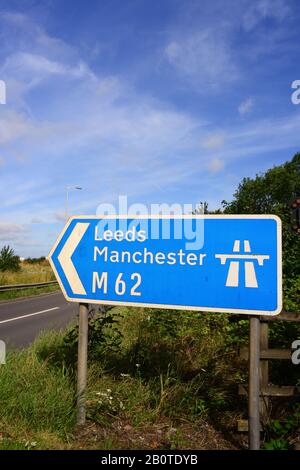 traffic passing m62 motorway sign to leeds and manchester at normanton ...