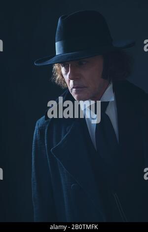 Mysterious victorian man in black coat and hat Stock Photo - Alamy