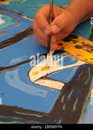 Artist hands brush painting abstract blue teal colors on canvas ...