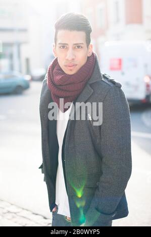 Young man in casual cloth wearing medical protective mask excited ...
