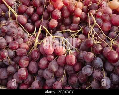 Bunch of grapes on the market counter. Pile of ripe grapes Stock Photo ...