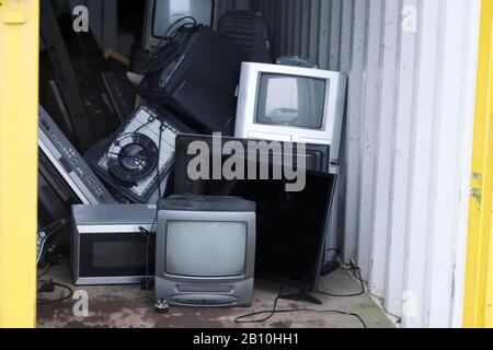 Televisions and computer monitors in a container at a recycling centre ...