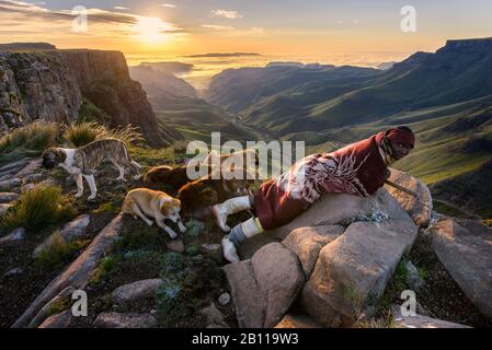 Basotho shepherd with view of Sani Pass, Drakensberg Mountains ...