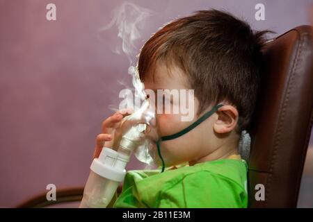 Little boy in a mask, treatments respiratory tract with a nebulizer at ...