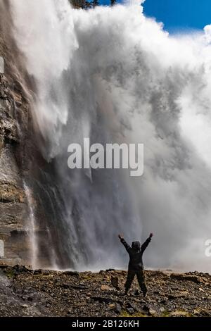 Hiker in front of Emperor Falls along the Robson River in Mount Robson ...