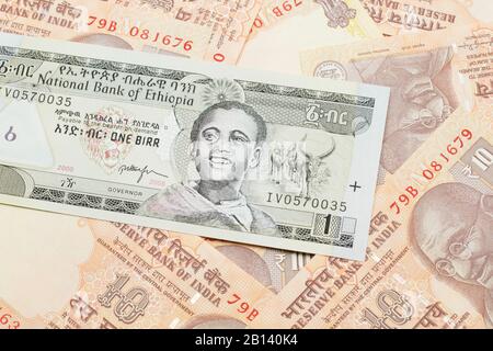 ten Ethiopian birr bank note and magnifying glass isolated on white ...