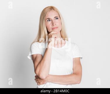 Pensive elegant mature woman enjoying summer evening in Mediterranean ...