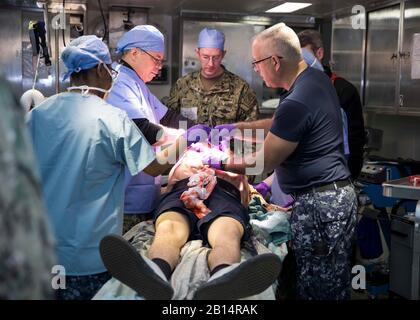 U.S. Navy Sailors with Fleet Surgical Team 7 identify the appendix ...