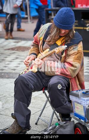 Guitarist Mark Allen busking on Queen Street, Cardiff, South Wales ...