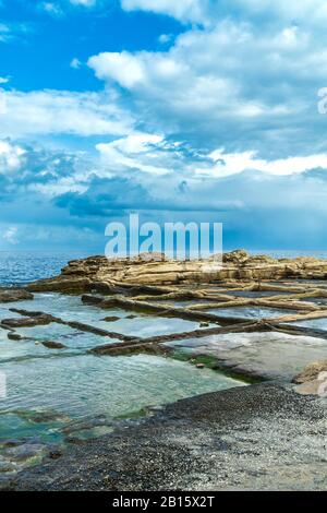 Traditional salt pans cut into the rock on the coast of Gozo, Malta ...