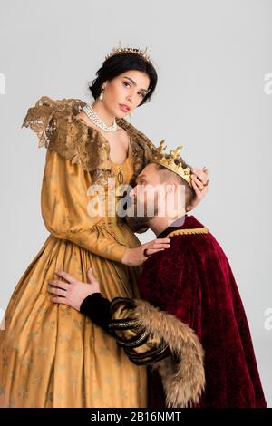 king with crown hugging attractive queen isolated on grey Stock Photo ...