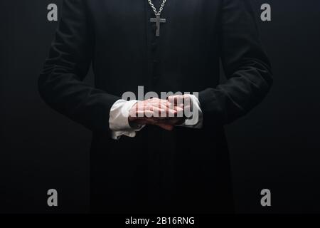 Folded hands of a priest Stock Photo - Alamy