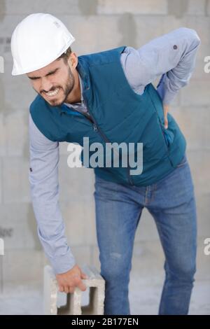 Mechanic Suffering From Back Pain On White Background Stock Photo - Alamy