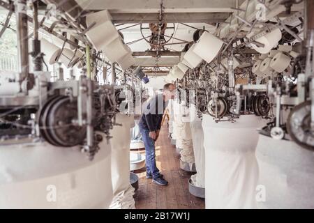 man working at a textile machine Stock Photo - Alamy