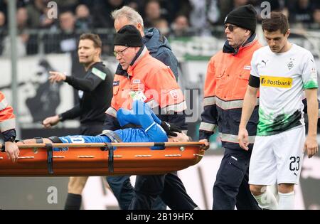 Injured football player being carried off the field by attendants from ...