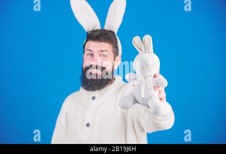 Grinning bearded man wear silly bunny ears. Easter symbol concept ...