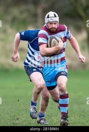 Muddy rugby player running in mud with ball. competition winning sports ...