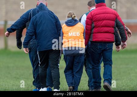 Injured football player being carried off the field by attendants from ...