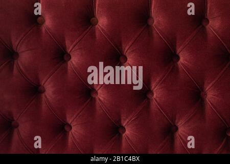Maroon red velvet capitone textile background, retro Chesterfield style ...
