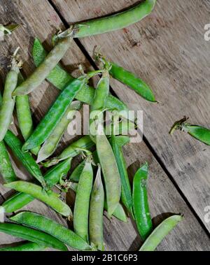 hearthy fresh green peas over a rustic wood table Stock Photo - Alamy