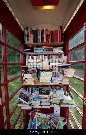 Red telephone box with library books inside Stock Photo - Alamy