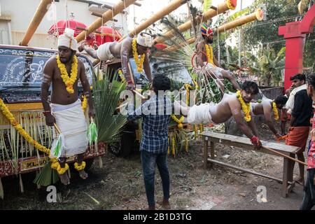 Devotees hanging by hook piercings as a ritualistic act of devotion ...