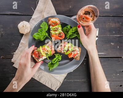 A plate with bruschetta with salmon and curd cheese. Sandwich with ...