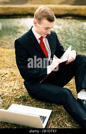 business man in a suit writes on a notebook work manager Stock Photo ...