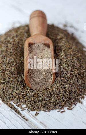 Cumin seeds heap over the wooden background Stock Photo - Alamy