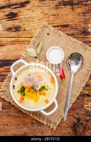Transparent duck broth in bowl with vegetables. Traditional bouillon ...