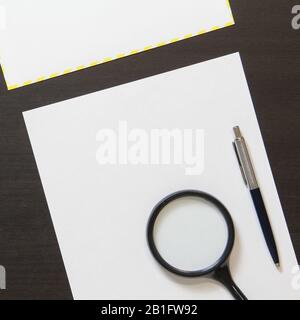 Pen and magnifier on color background Stock Photo - Alamy