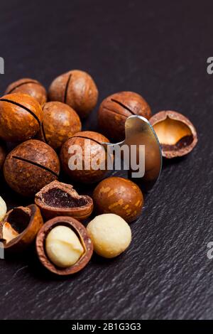 Whole and open macadamia nuts with key on black background Stock Photo ...