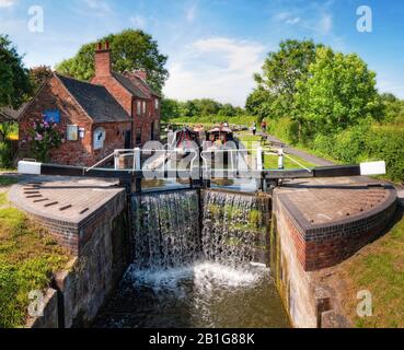 Narrowboat passing through the canal lock, Bunbury Locks, Shropshire ...